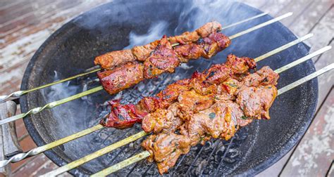 Russian Shashlik With Skewers On A Round Grill Stock Photo At Vecteezy