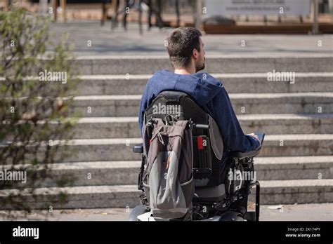 Person With Disability On Electric Wheelchair Stopping At The Bottom Of