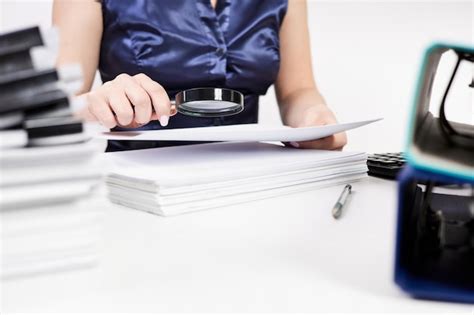 Premium Photo An Office Worker Examines Documents Through A