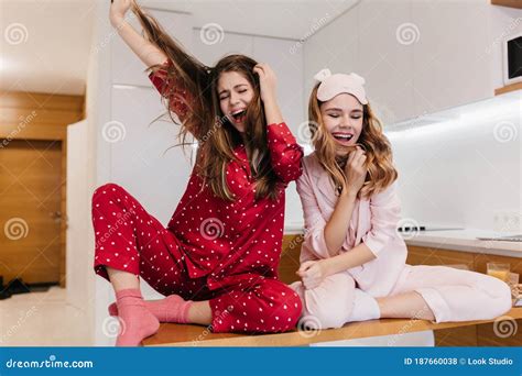 Chilling Girl In Pink Socks Sitting On Wooden Table Indoor Photo Of