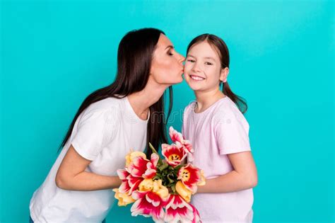 Photo Of Mother Kiss Her Daughter Festive Event Isolated On Cyan Color