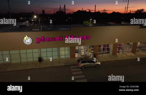 Planet Fitness Gym Aerial At Night With Front Entrance Sign And Logo