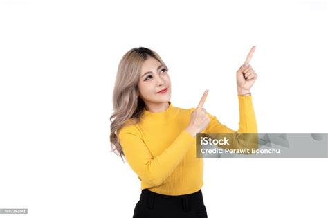 Smiling Happy Asian Woman With Her Finger Pointing Isolated On White