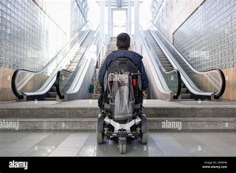 Person With Disability On Electric Wheelchair Stopping At The Bottom Of