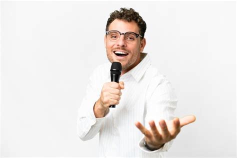 Premium Photo Brazilian Man Picking Up A Microphone Over Isolated