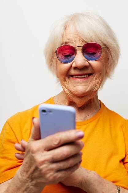 Premium Photo Senior Woman Using Mobile Phone Against White Background