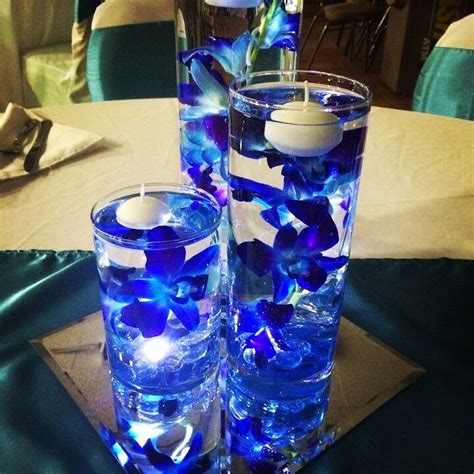 Three Cylinder Blue Dyed Orchids With White Submersible Lights And