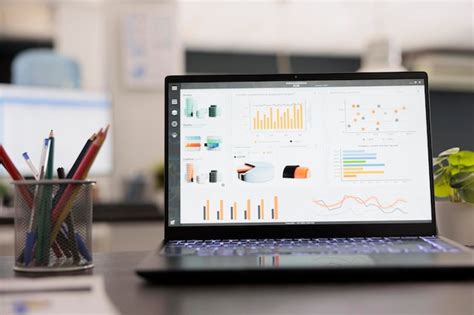 premium photo portable computer with statistical infographics on a