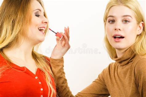 Woman Applying Her Friend Lipstick On Lips Stock Image Image Of