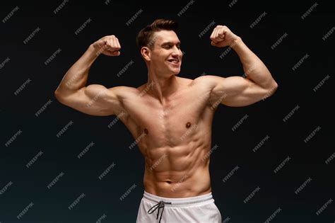Premium Photo Happy Athletic Model Demonstrating Biceps While Posing