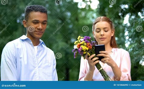 Gadget Addicted Girl With Flowers Chatting On Smartphone Ignoring
