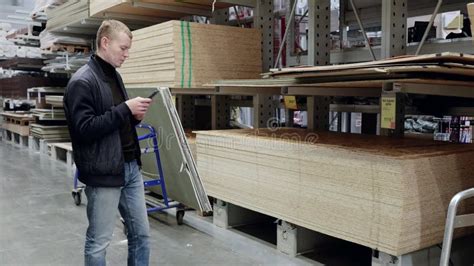Choosing Lumber For Home Renovation Construction Worker Selecting