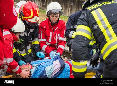 Emergency Service Personnel Free An Injured Driver At The Scene Of A