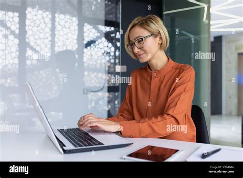 Beautiful Young Businesswoman Inside Office Working With Laptop Blonde With Short Hair Typing