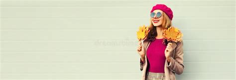 Autumn Portrait Of Happy Smiling Young Woman With Yellow Maple Leaves