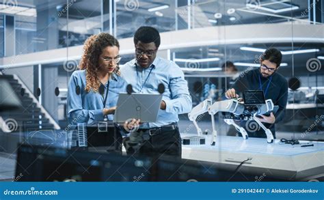 Portrait Of Two Multiethnic Female And Male Engineers Use Laptop
