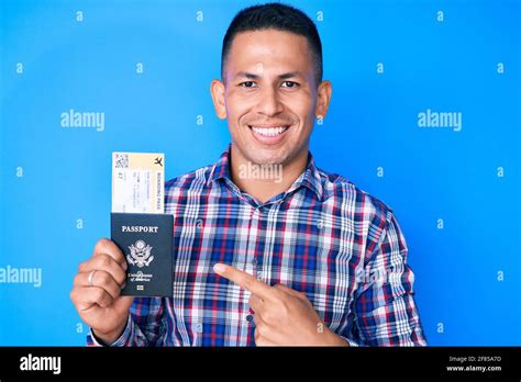 Young Handsome Latin Man Holding United States Passport And Boarding