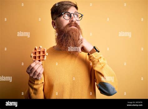 Redhead Irish Man With Beard Eating Sweet Belgian Waffle Pastry Over