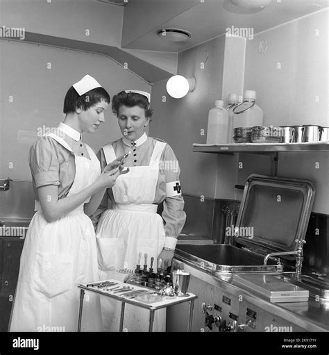 In The 1950s Two Dental Nurses In A Room Where The Dental Instruments