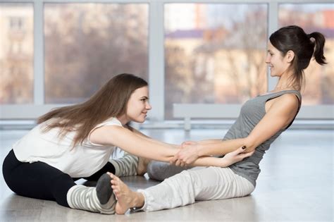 Woman Helping Another Stretch Back Photo Free Download