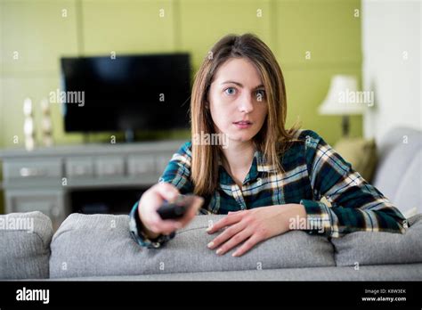 Beautiful Woman Watching TV Sitting On Couch At Home Stock Photo Alamy