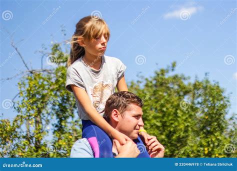 Defocused Brother Riding Sister On Back Portrait Of Happy Girl On Man