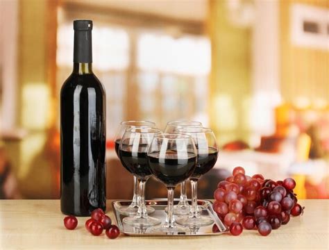 Premium Photo Red Wine In Glass And Bottle On Room Background