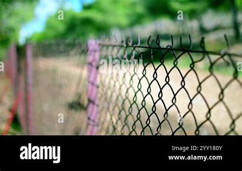 Slow Motion Camera Movement Of A Rusty Old Iron Fence In A Park