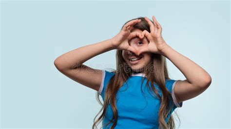 girl creating heart shape with hands while smiling stock image image