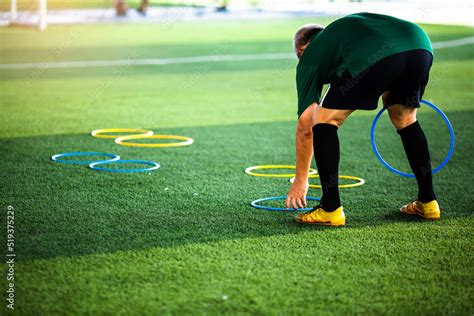 Coach Is Putting The Marker Ring For Soccer Training To Run And Jump