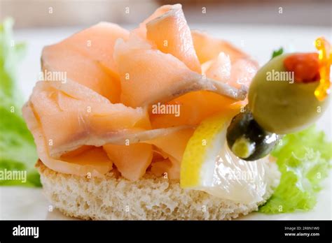 A Delicious Smoked Salmon Canape With Lemon Cucumber And Olive Stock