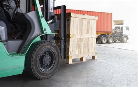 Forklift Tractor Unloading Wooden Crates At Warehouse Truck Loading
