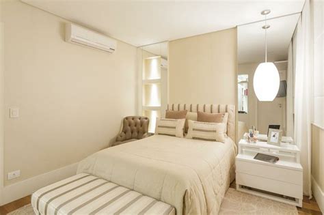 A Bedroom With A Bed Dresser And Mirror On The Wall Next To An Air
