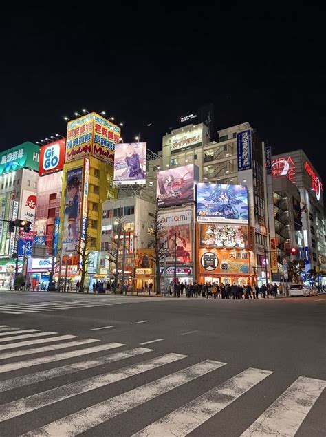 Vibrant Akihabara Street Scene At Night With Bright Neon Signs And