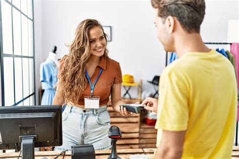 Man And Woman Paying Purchase Using Credit Card And Data Phone At