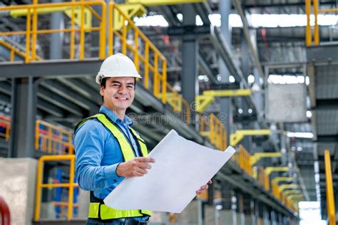 Portrait Of Professional Engineer Hold Construction Chart Or Plan And