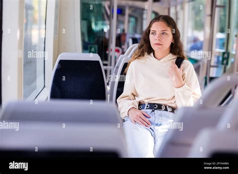 Portrait Of A Focused Looking Into The Distance Girl Riding In Public