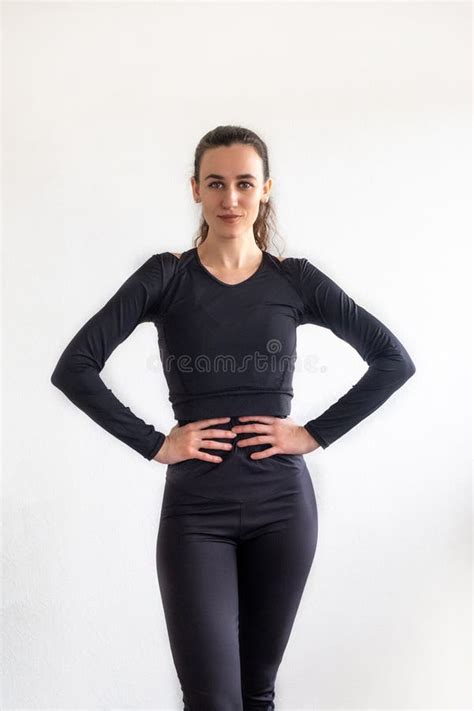 Beautiful Young Woman Dressed In A Black Sports Uniform After Exercise