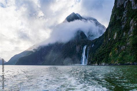 Photograph Of Waterfalls From A Boat On A Misty And Rainy Day In