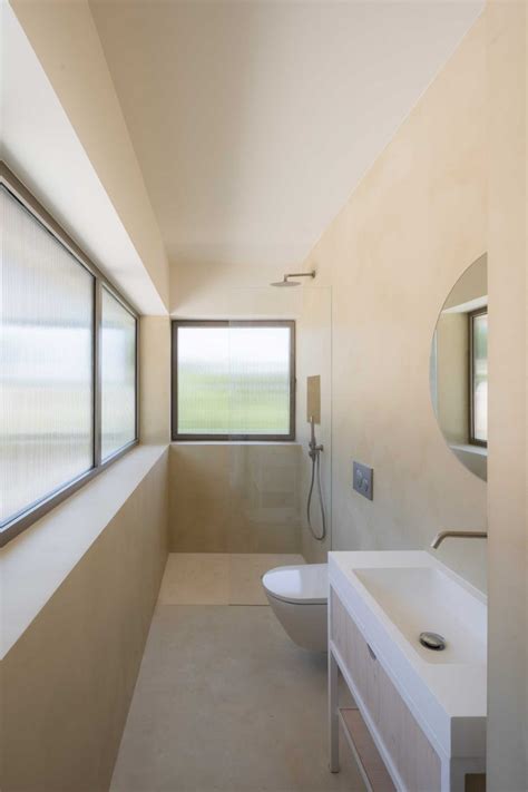 Fluted Concrete Walls Cut By Continuous Window Openings Define This Villa