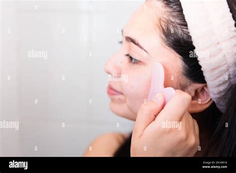 Side View Young Latin Woman Using Chinese Gua Sha Quartz Stone To