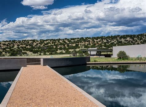 Measuring Acres The Site S Main Residence Hovers Above A Reflecting Pool And Directly