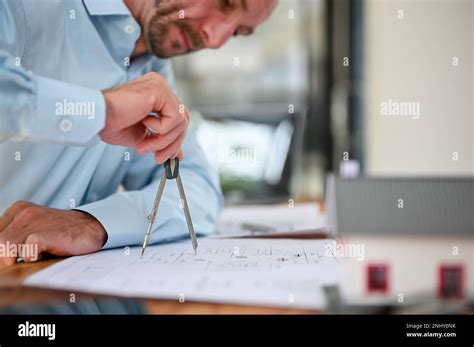 Professional And Smart Caucasian Male Engineer Or Architect Using A Divider Compass Drawing And