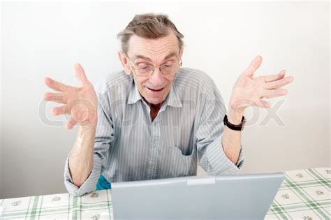 Old Man Making Happy Gesture In Front Of Computer Stock Photo Colourbox