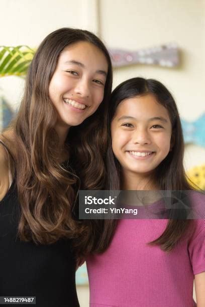 Casual Portrait Of Two Young Hawaiian Teenage Adolescent Girls Stock