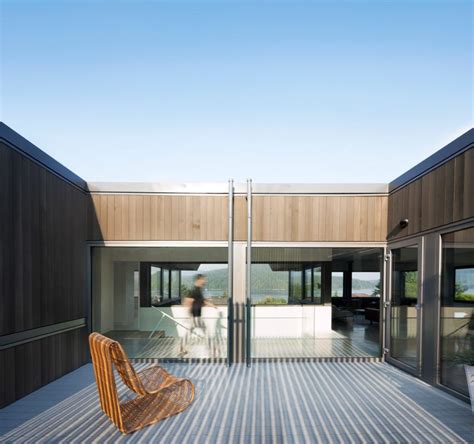 Darcy Jones Defines Deep Cove House With Slanted Wood Clad Walls