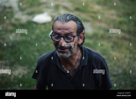 A Serbian Senior 60 And Vibrant In Glasses And Long Hair Enjoying
