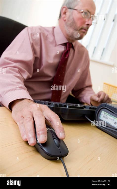 MODEL RELEASED Computer Use Man Typing On A Computer Keyboard Photographed In The UK Stock