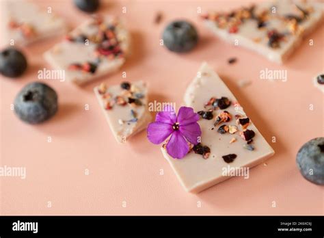 Crushed Pink Chocolate With Blueberries And Flowers Broken Bars With Nuts And Sublimated