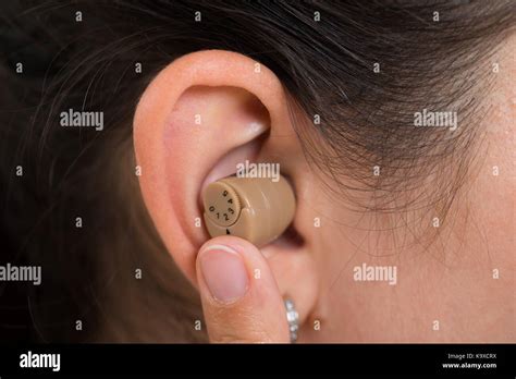 Close Up Of Woman Ear Wearing Hearing Aid Stock Photo Alamy